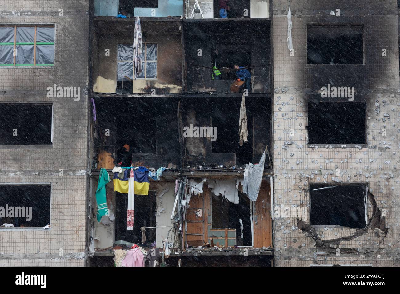 The facade of a damaged apartment block. Broken windows and traces of ...