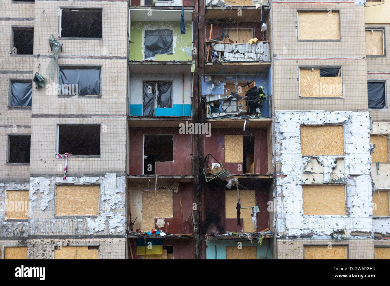 The facade of a damaged apartment block. Broken windows and traces of ...