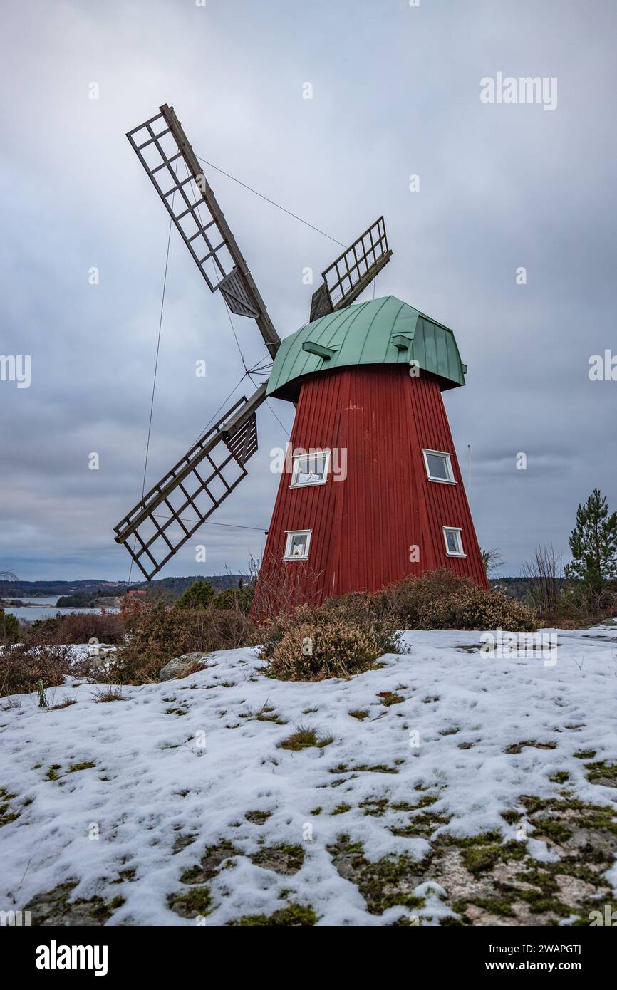 Typical historical red wooden windmill in a winter landscape. The ...