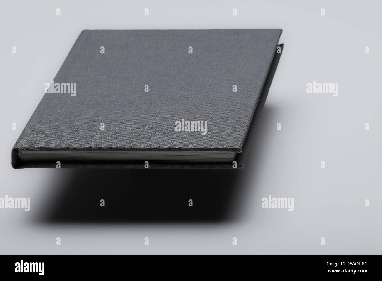 Empty grey floating book mockup. Studio shot of a blank closed book ...