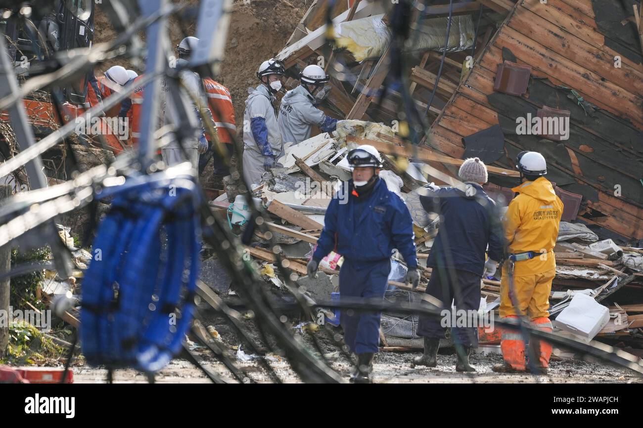 Ishikawa Prefecture, Japan. 6th Jan 2024. Firefighters conduct a search ...