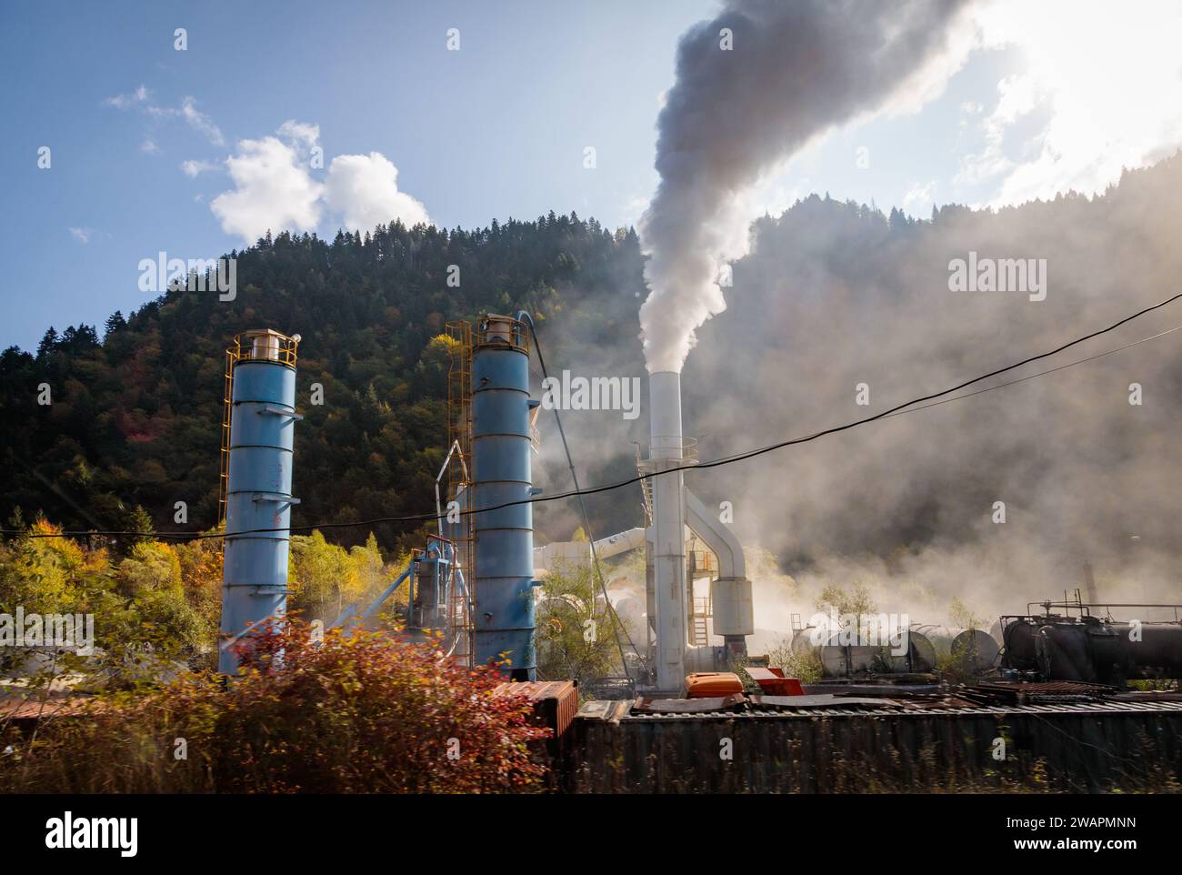 Industrial landscape with smoking factory chimneys on the background of ...