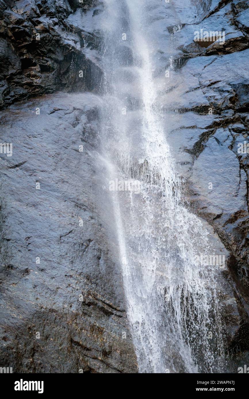 A multi-level waterfall among mountain peaks, creating an impressive ...