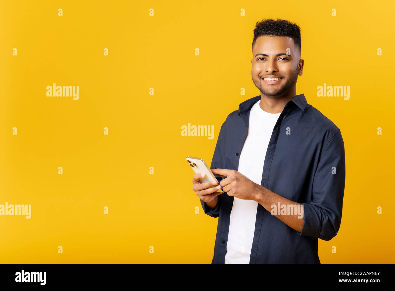 Online communication. Handsome happy indian man using smartphone ...