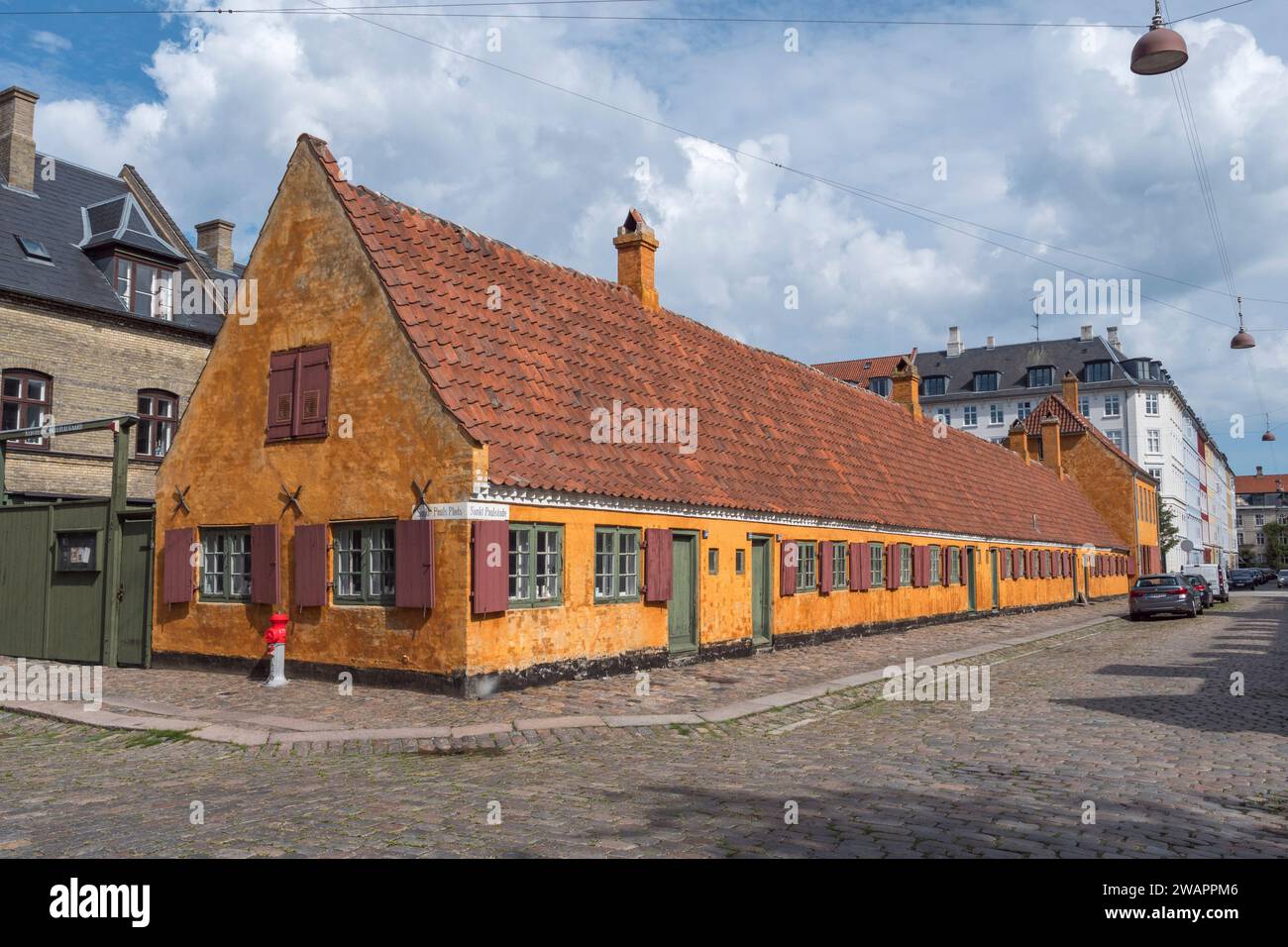 Classic yellow cottages in the historic row house district Nyboder ...