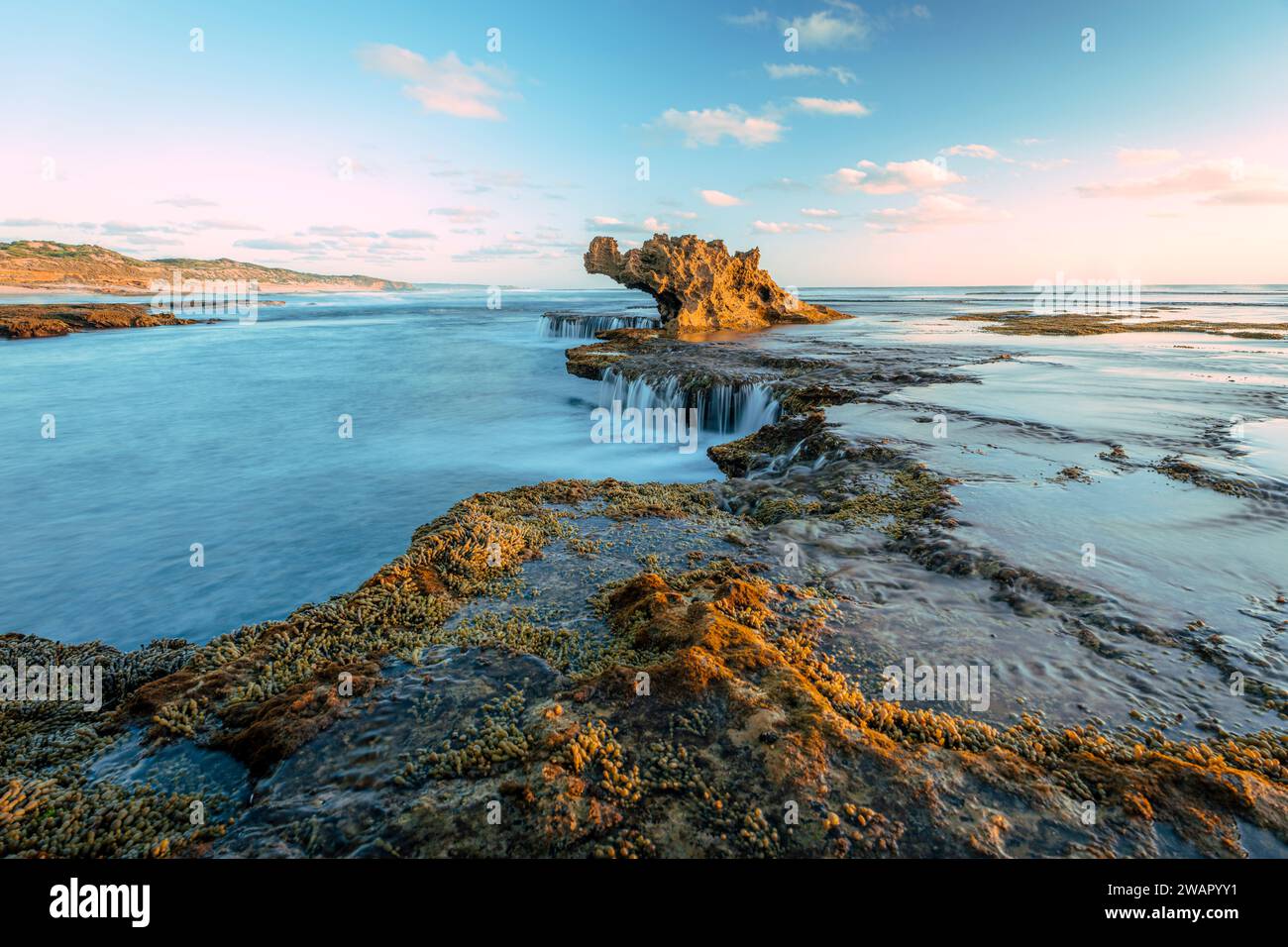 A scenic view of beautiful Dragon Head Rock at sunset in Australia ...