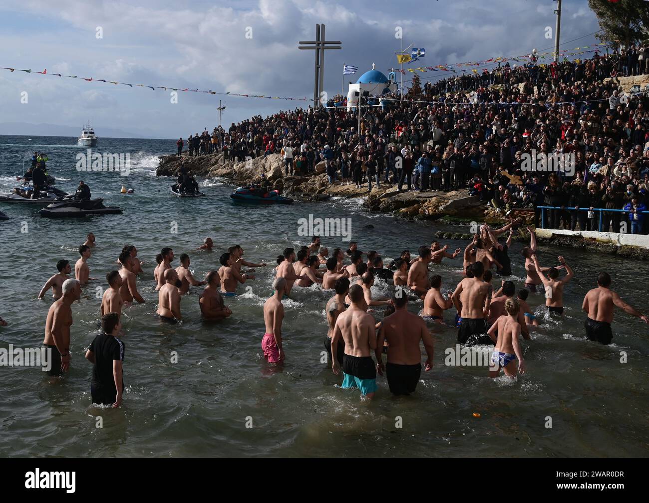 Piraeus, Athens, Greece. 06 January 2024. Swimmers try to catch a ...