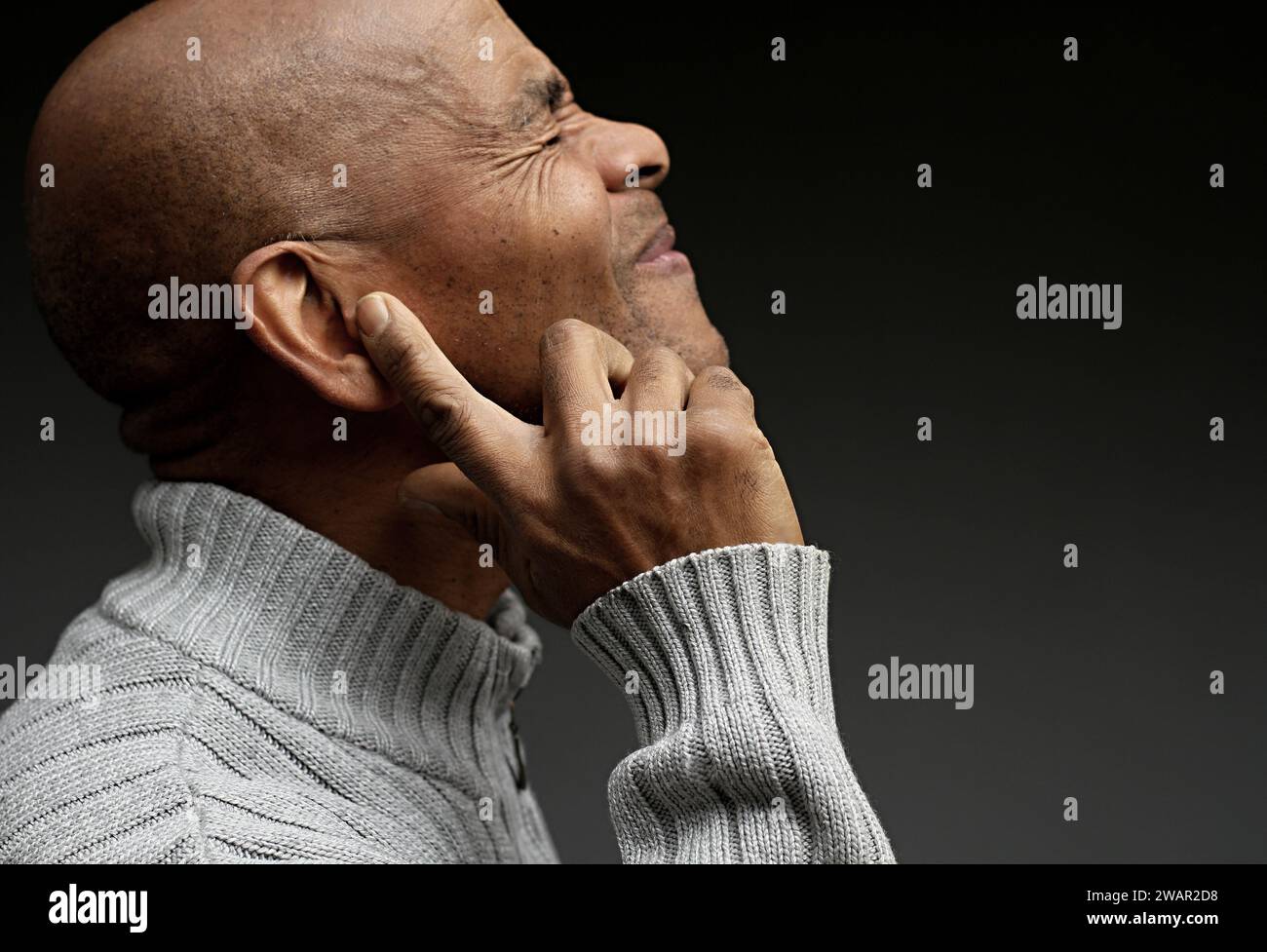 deaf man suffering from deafness and hearing loss on grey black ...