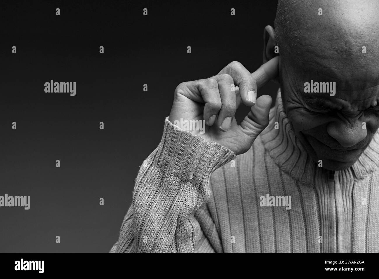 deaf man suffering from deafness and hearing loss on grey black ...