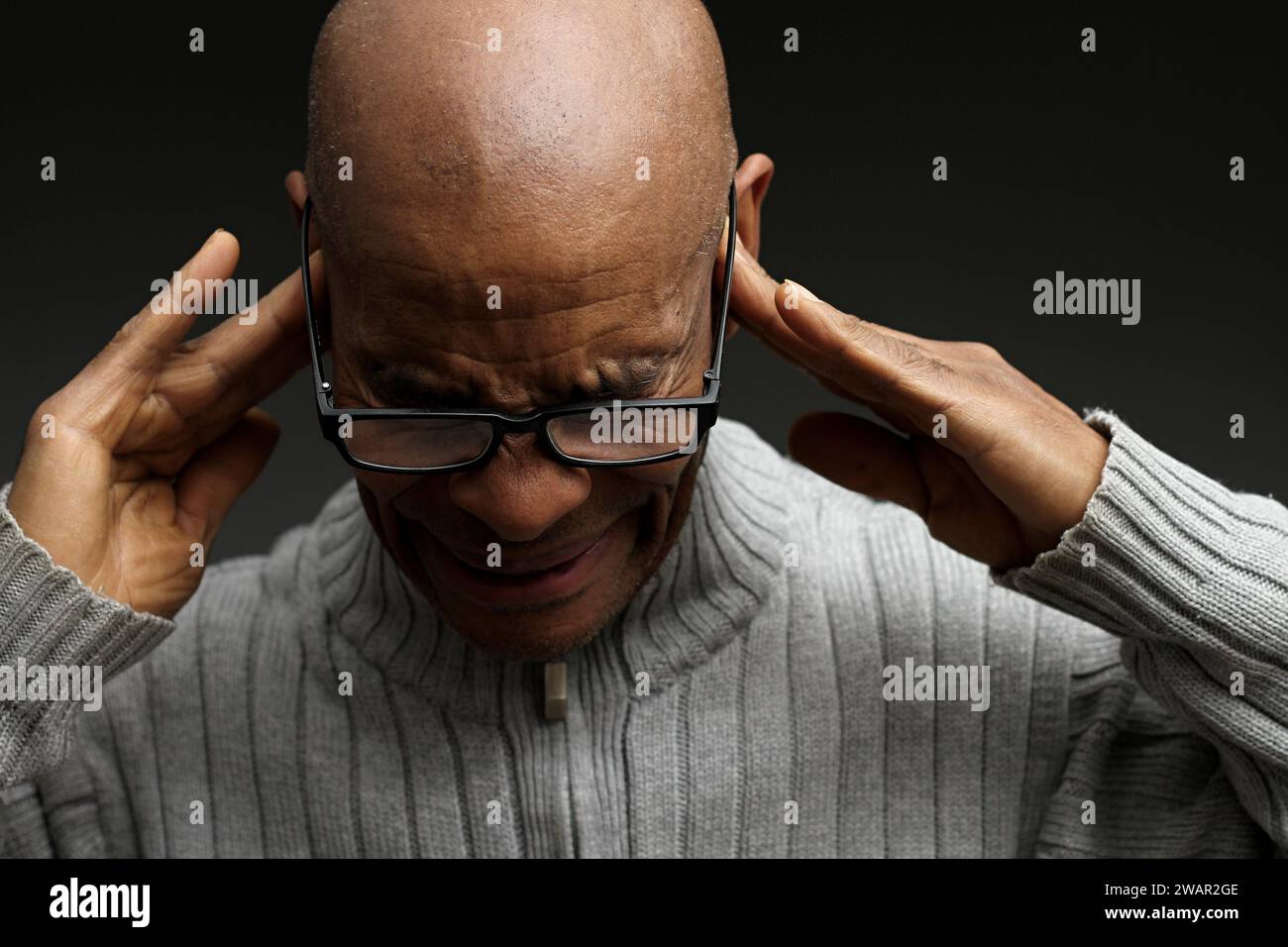 deaf man suffering from deafness and hearing loss on grey black ...