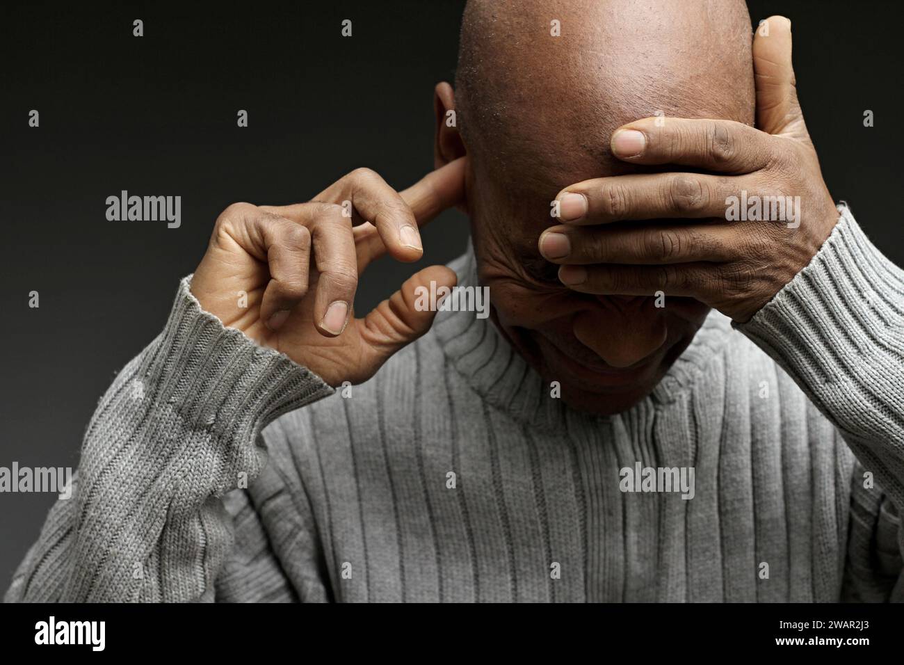 deaf man suffering from deafness and hearing loss on grey black ...