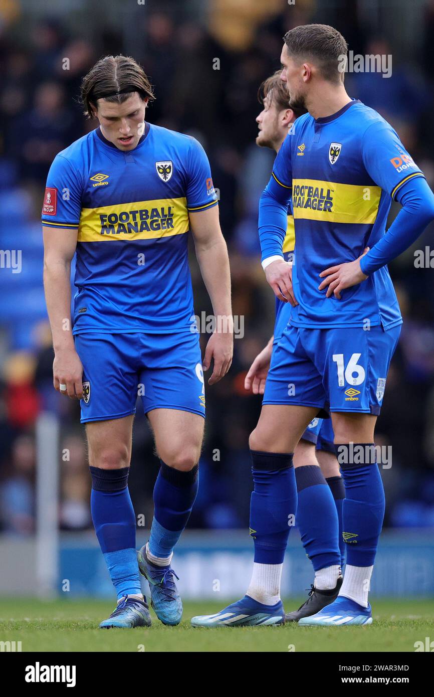 Wimbledon's Josh Davison (left) and James Ball react after the Emirates ...