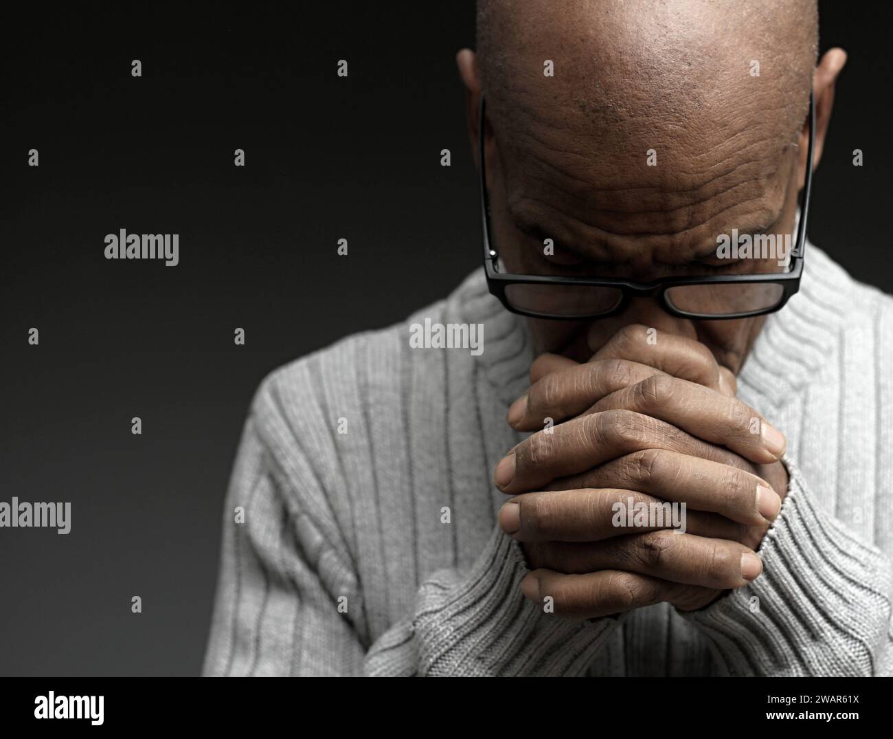 praying to god for forgiveness Caribbean man praying with grey black ...
