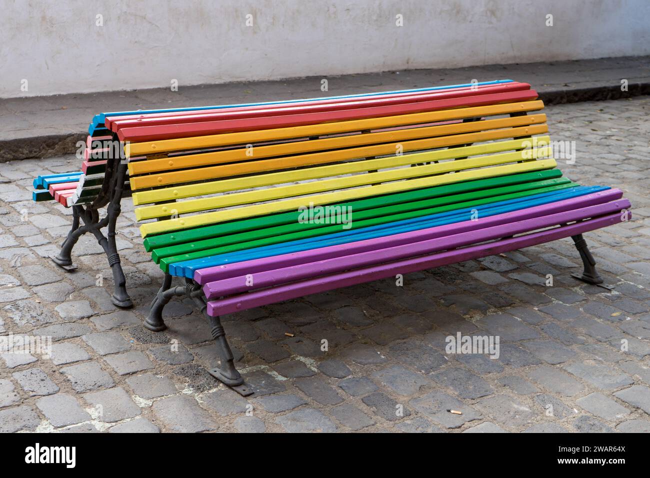 Bench painted in rainbow colors Stock Photo - Alamy