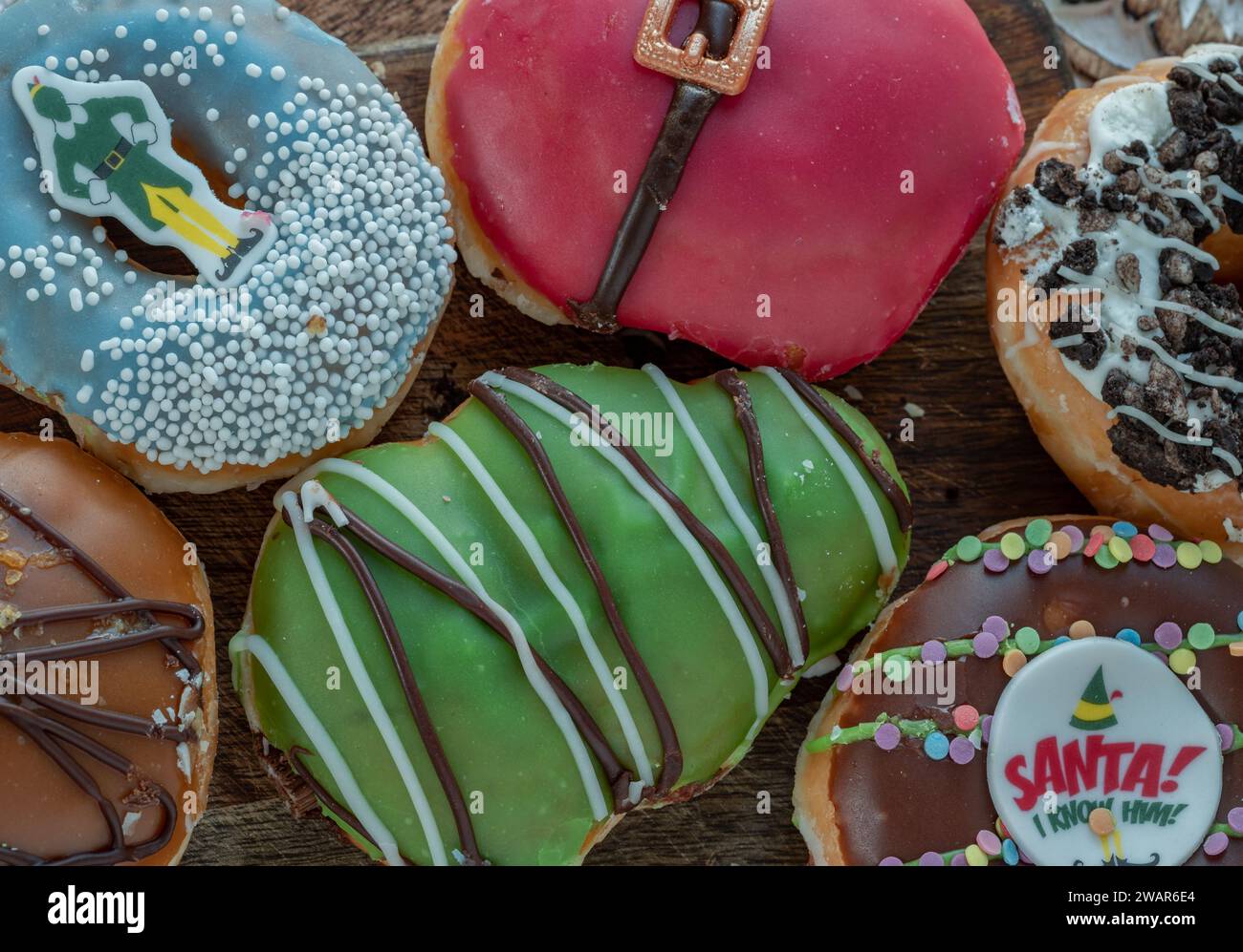 Many Original Glazed Doughnuts placed on wooden cutting board. The ...