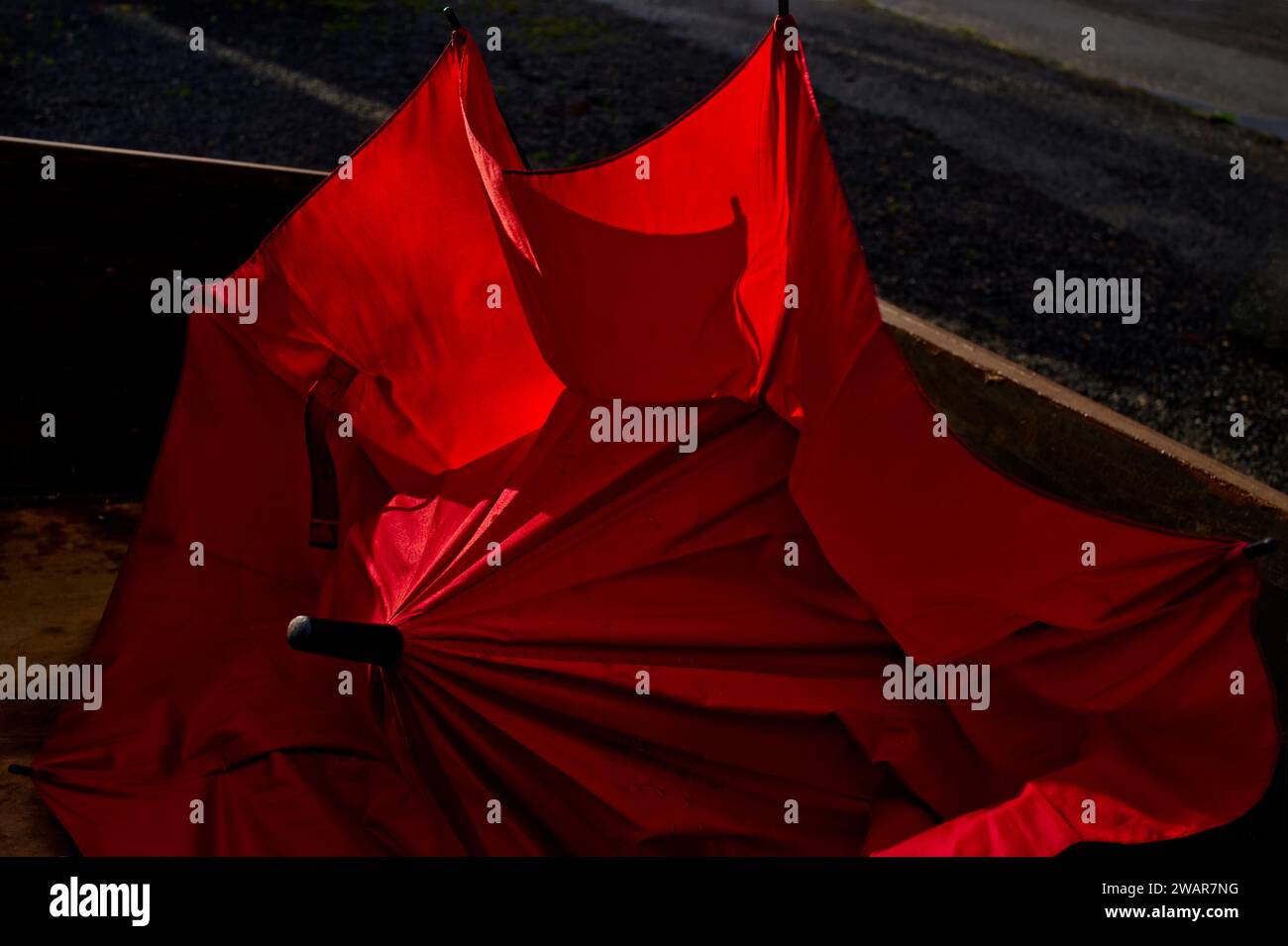 Sunlight and shadows at the textile fabric of a red umbrella Stock ...
