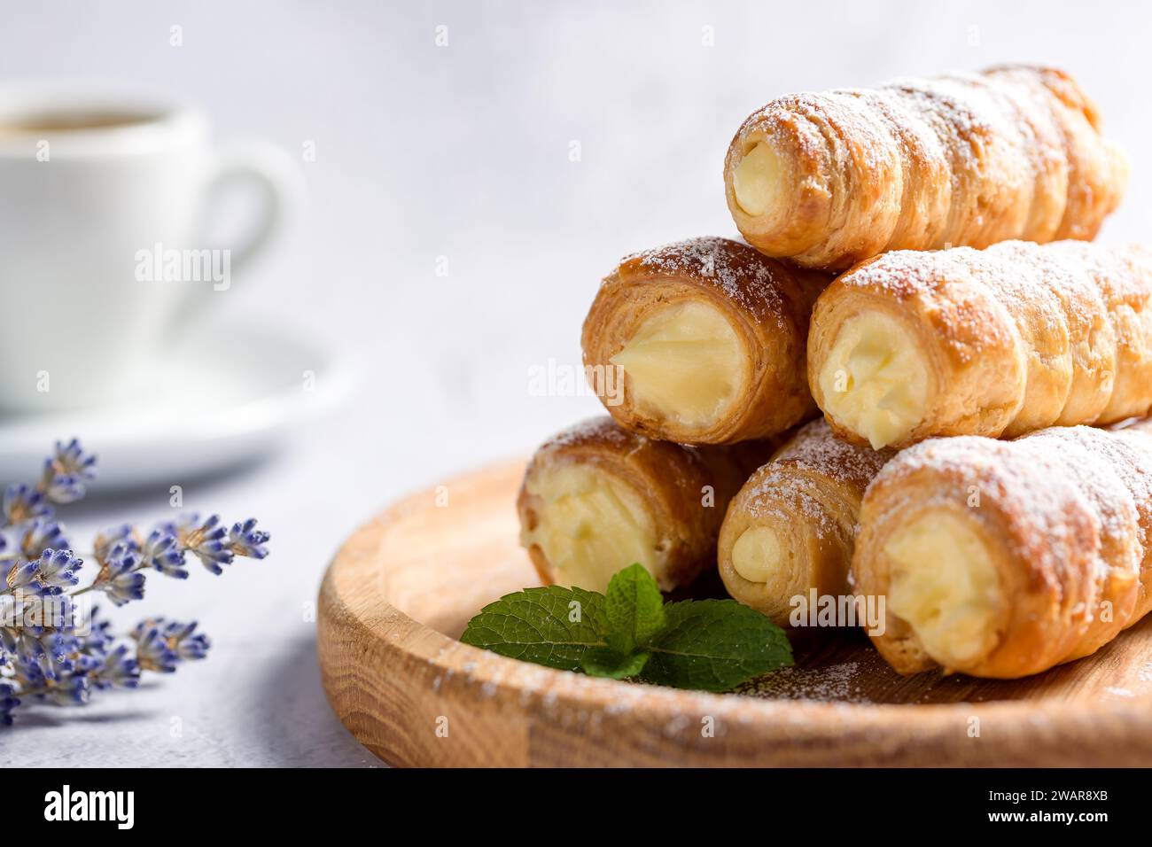 Delicious puff pastry tubes filled with custard Stock Photo - Alamy