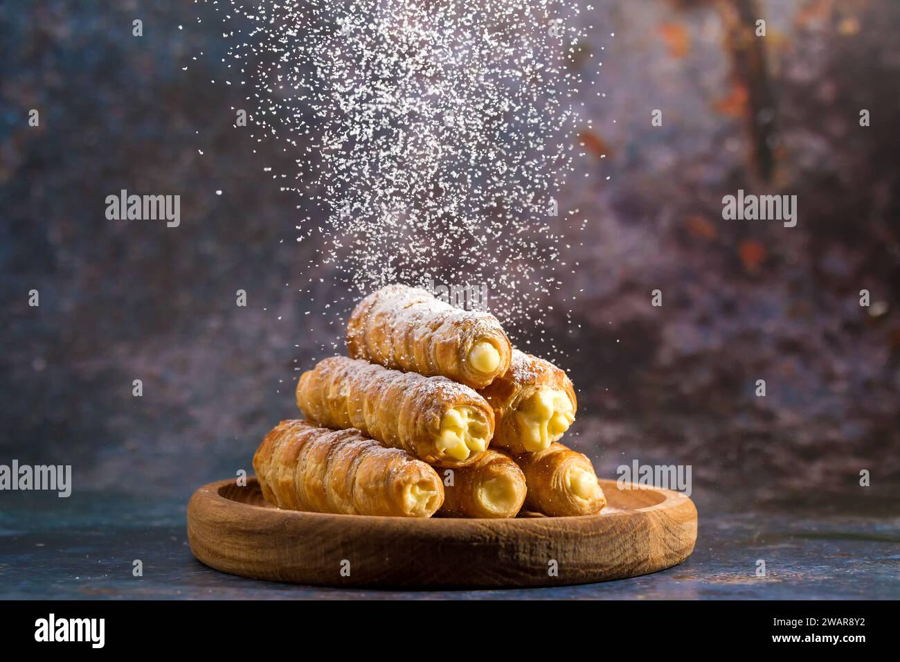 Delicious puff pastry tubes filled with custard. Powdered Sugar Stock ...