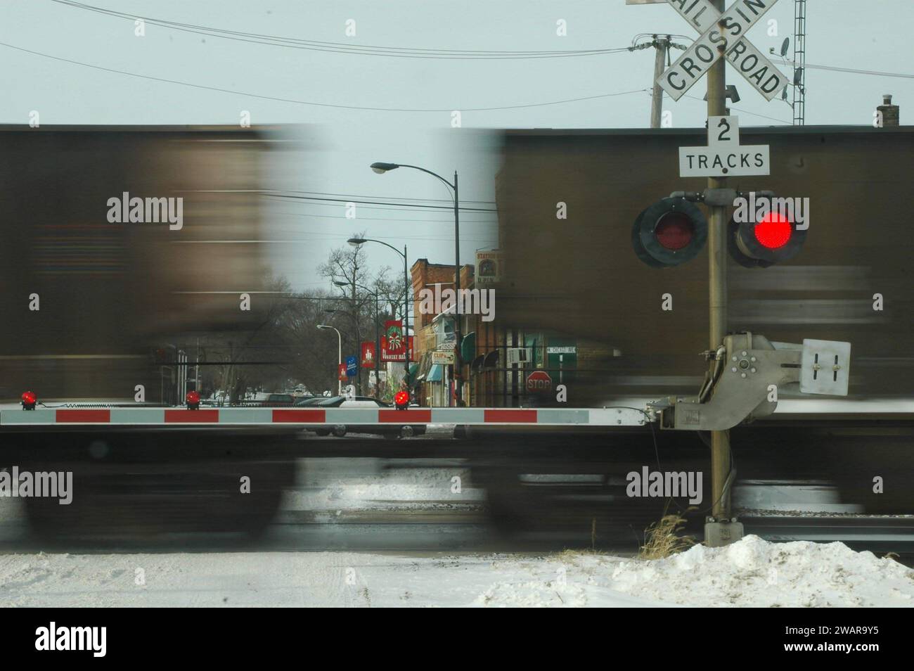 gate down at railroad crossing cars blurred Stock Photo - Alamy