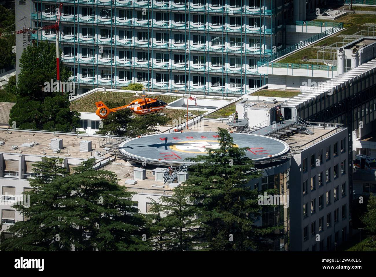 An aerial view of a helicopter hovering above a modern cityscape Stock ...