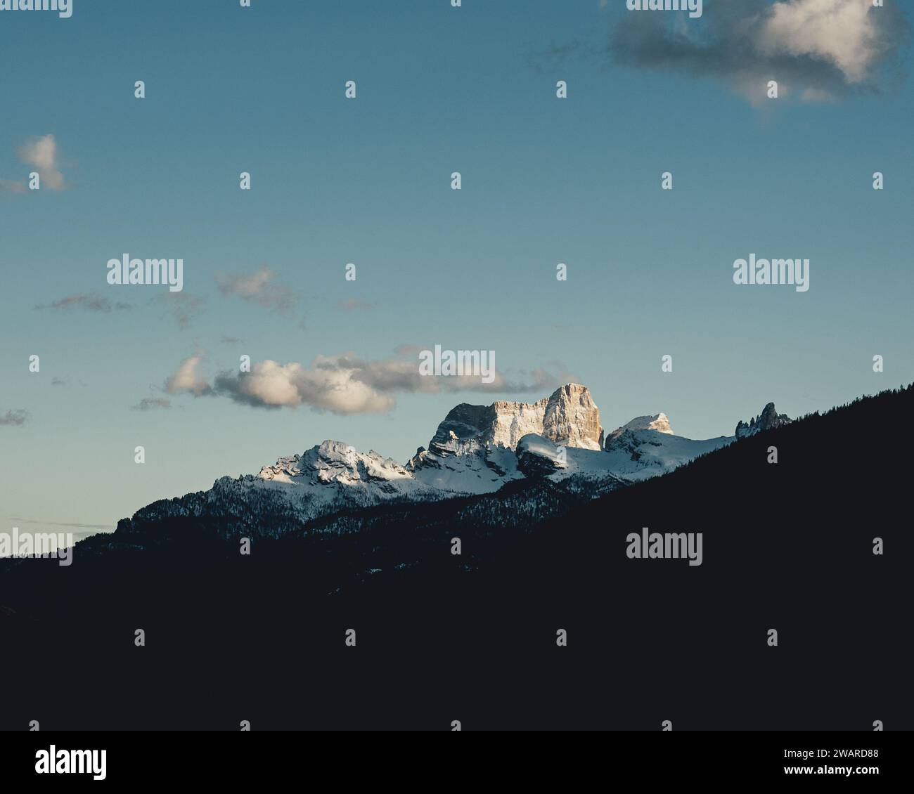 A scenic vista featuring two majestic mountain peaks, surrounded by a ...