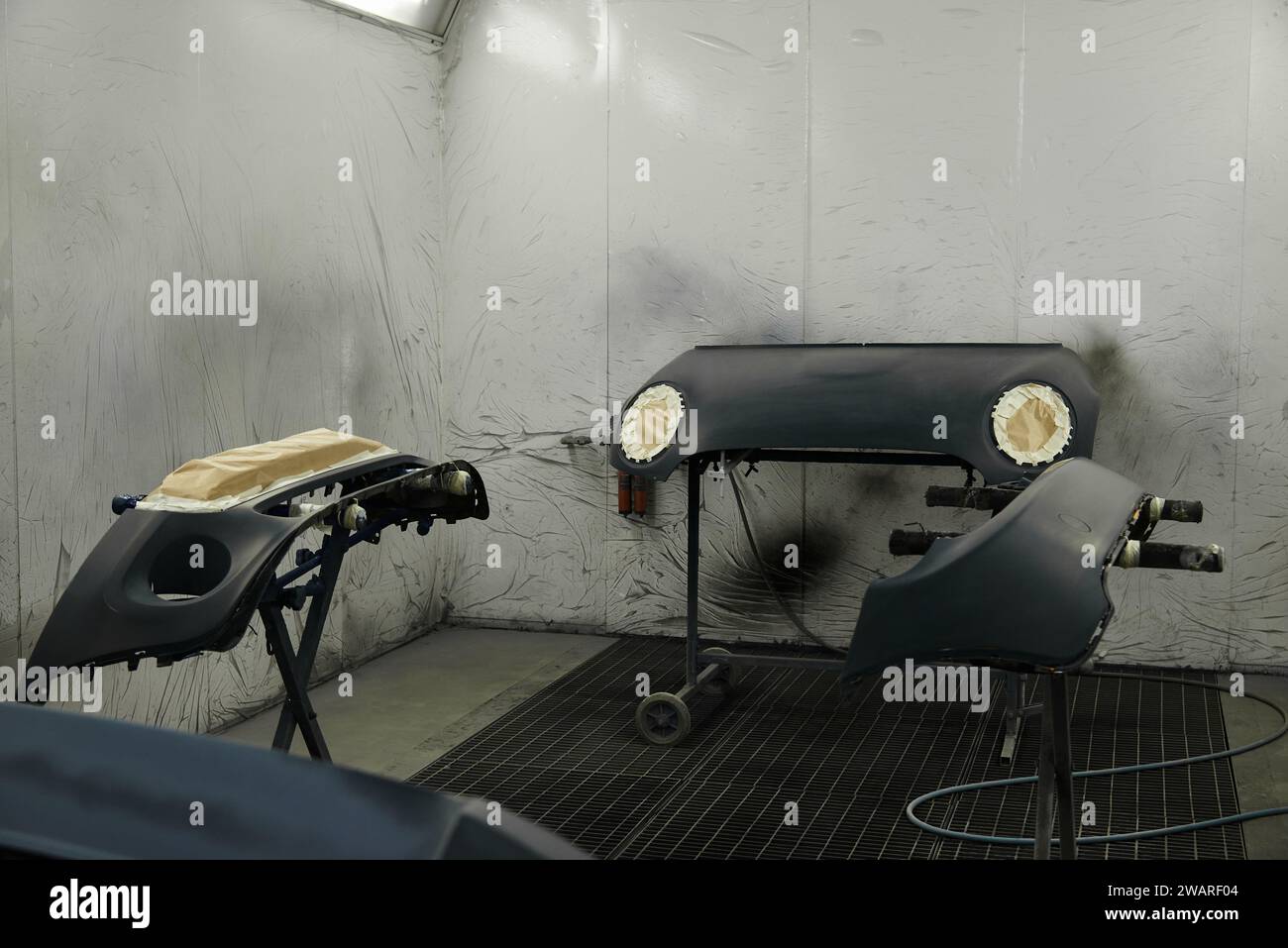 The photograph captures the scene of an automotive workshop, showcasing ...