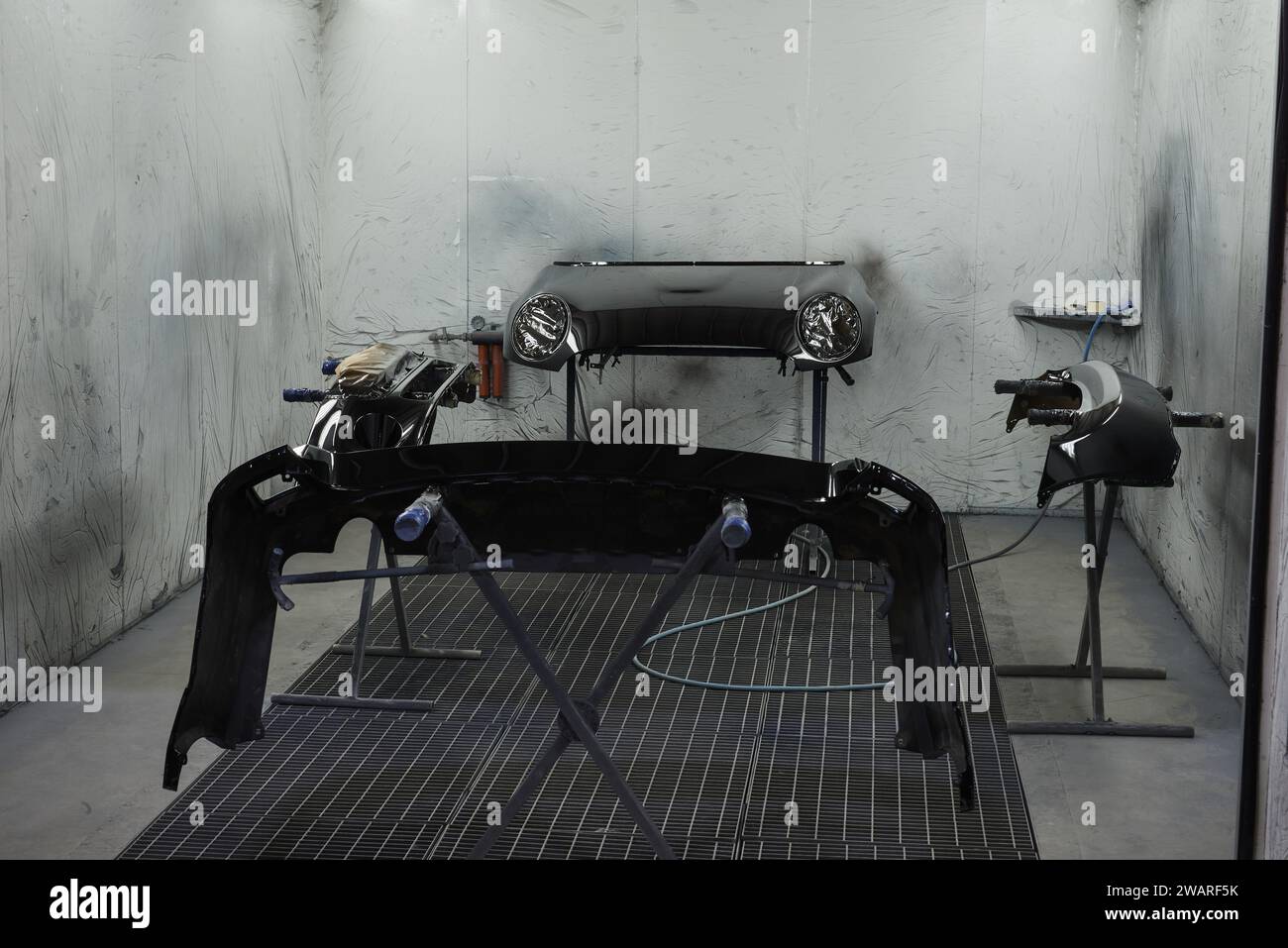 The photograph captures the scene of an automotive workshop, showcasing ...