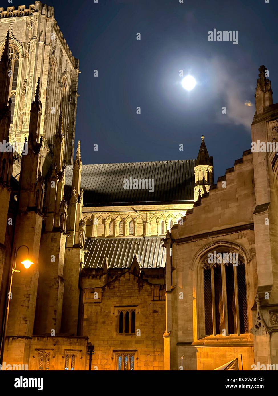 A majestic full moon illuminates a magnificent clock tower at night ...