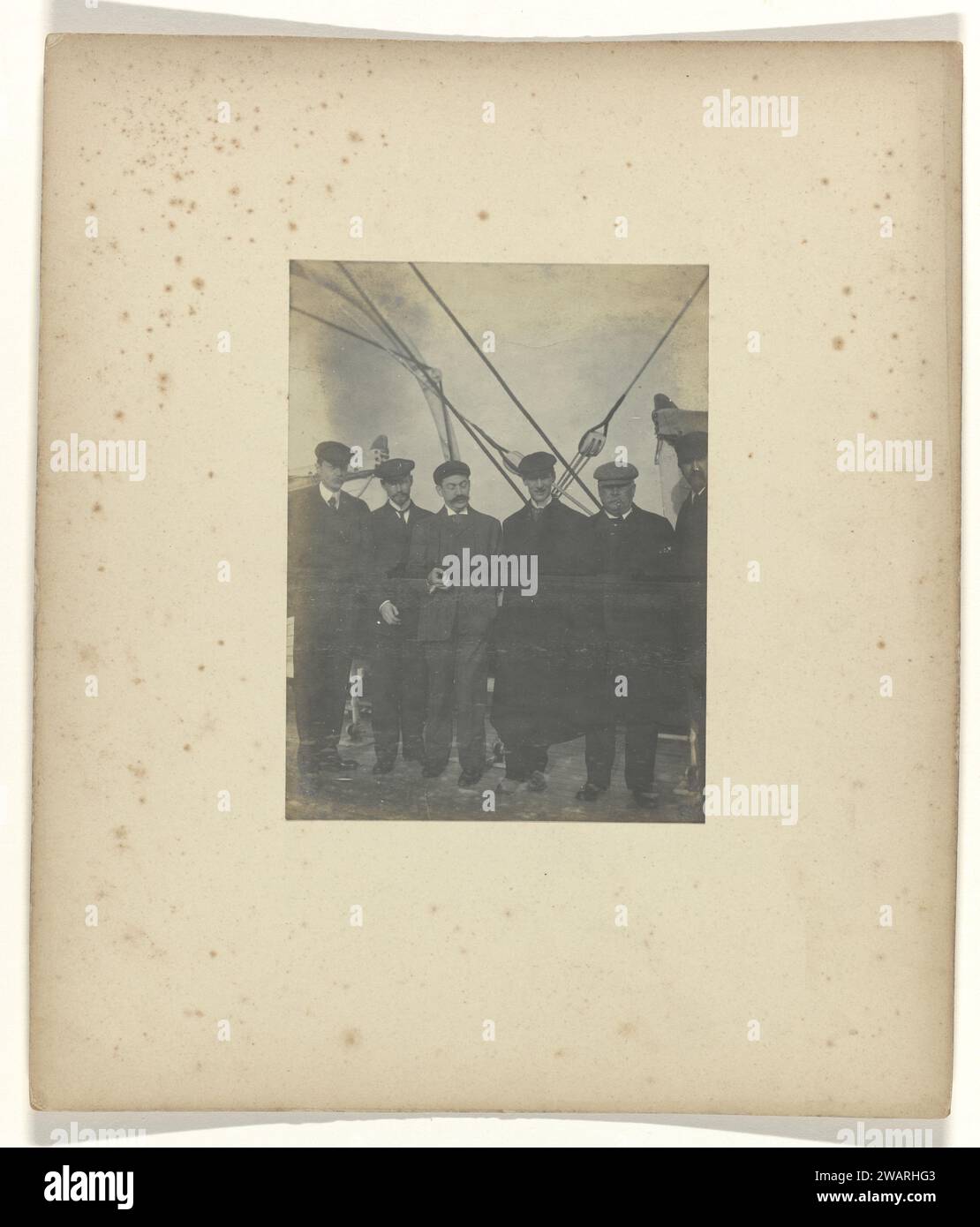 Group portrait of six men on the deck of a ship, with Jan C. Schüller ...