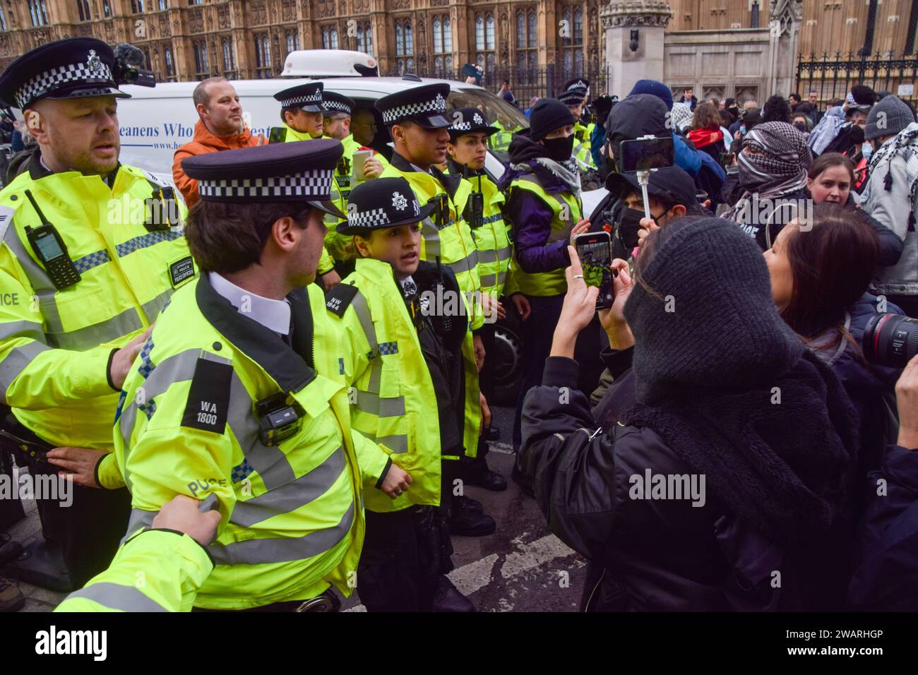 London, UK. 6th January 2024. Police officers scuffle with pro ...