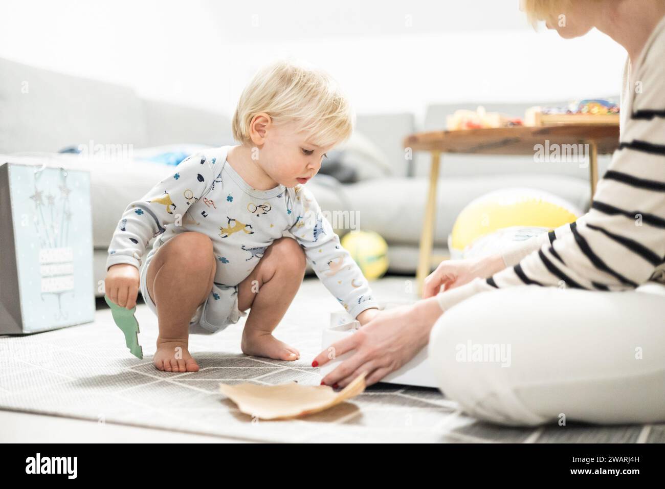 Parents playing games with child. Little toddler doing puzzle. Infant ...