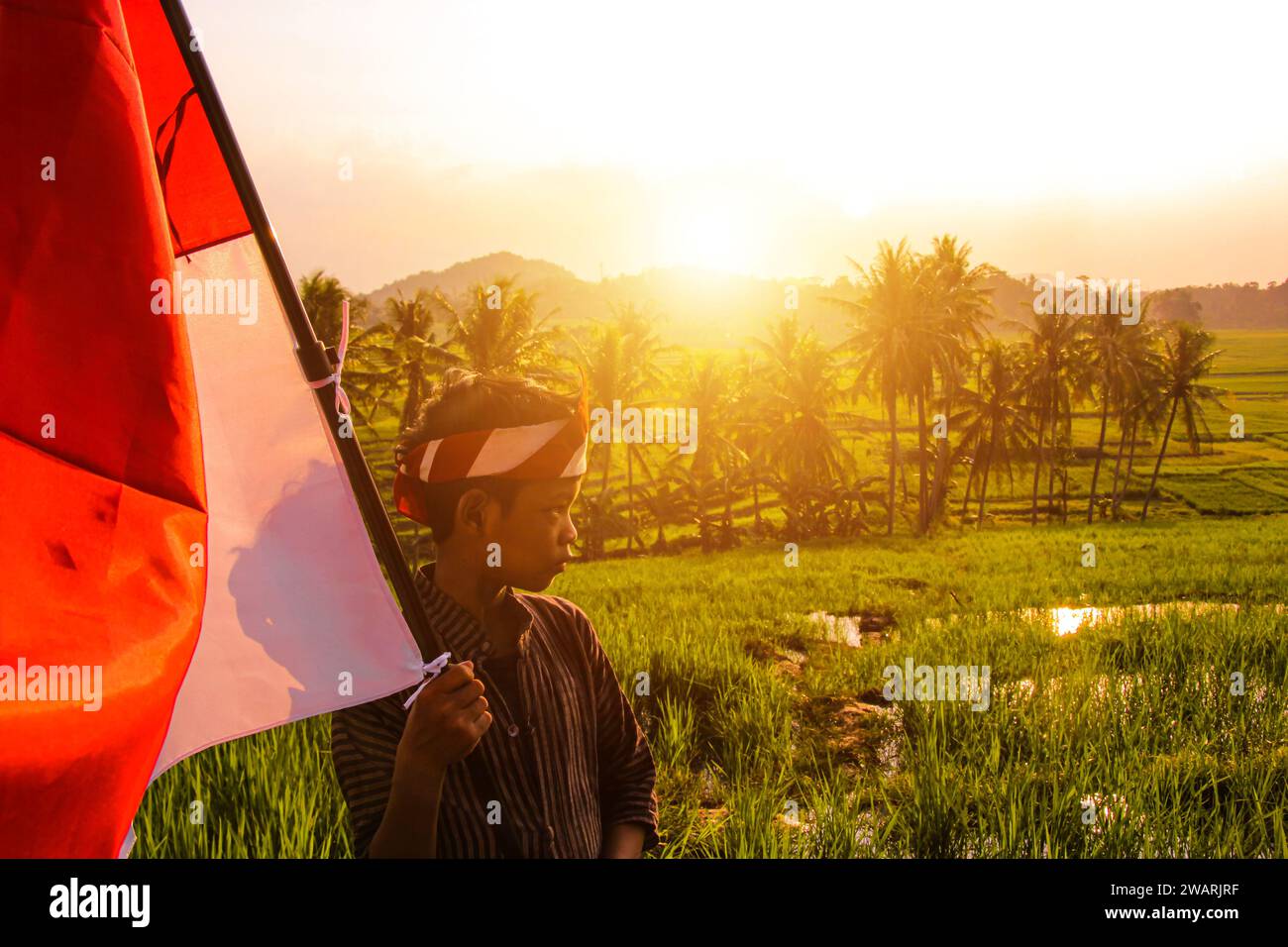 asian teenager in traditional javanese dress holding indonesian flag ...