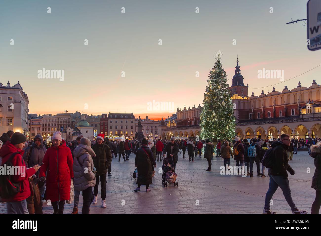 KRAKOW, POLAND - DECEMBER 27, 2023: Many people on the old market ...