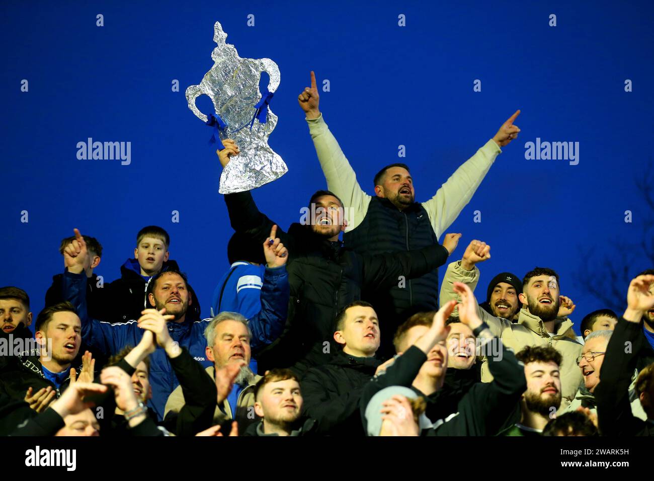 A fan in the stands holds up a replica of the FA Cup trophy during the ...