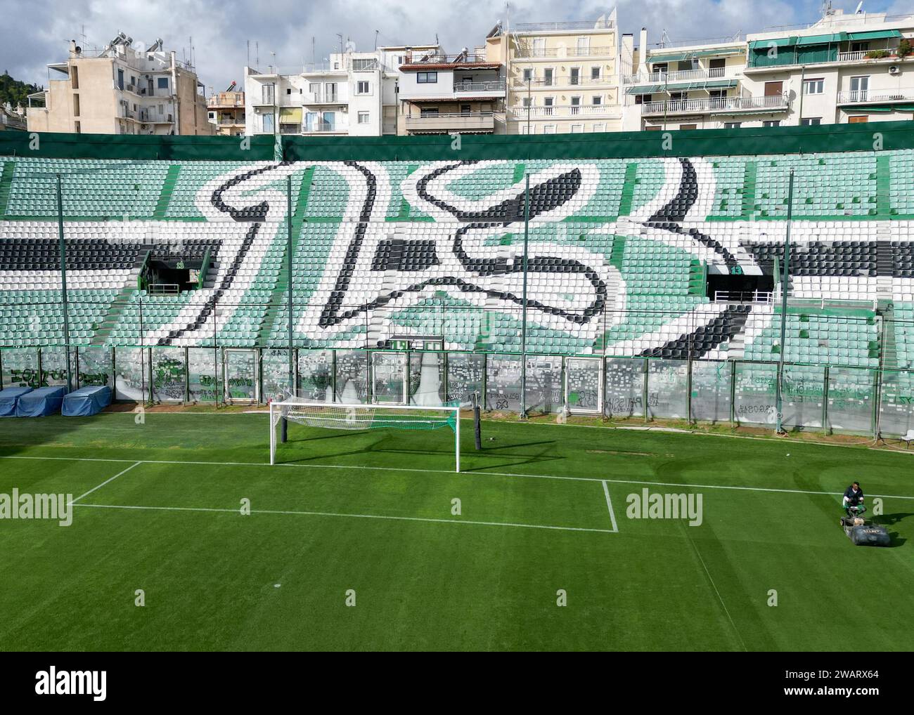 Ground staff are cutting the grass at Apostolos Nikolaidis Stadium ...