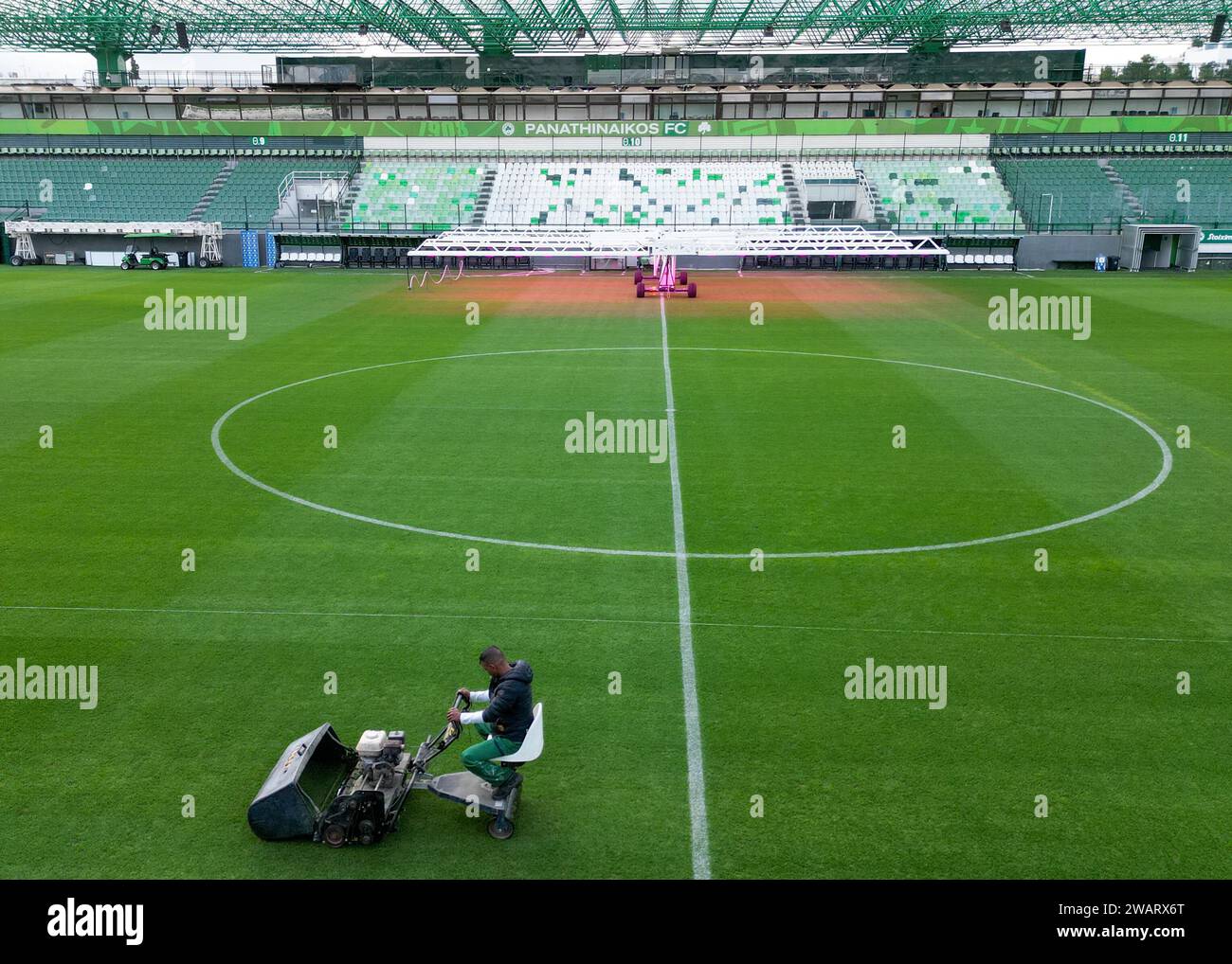 Ground staff are cutting the grass at Apostolos Nikolaidis Stadium ...