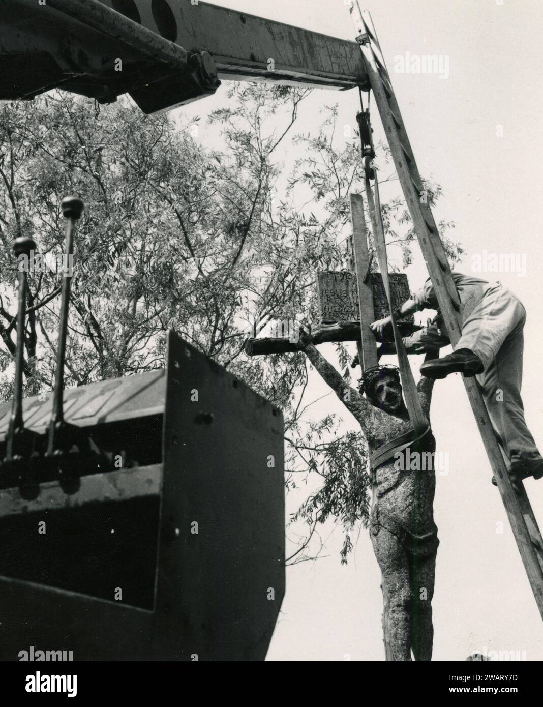 Lifting up a human sized Christ on the cross with a crane, Denmark ...