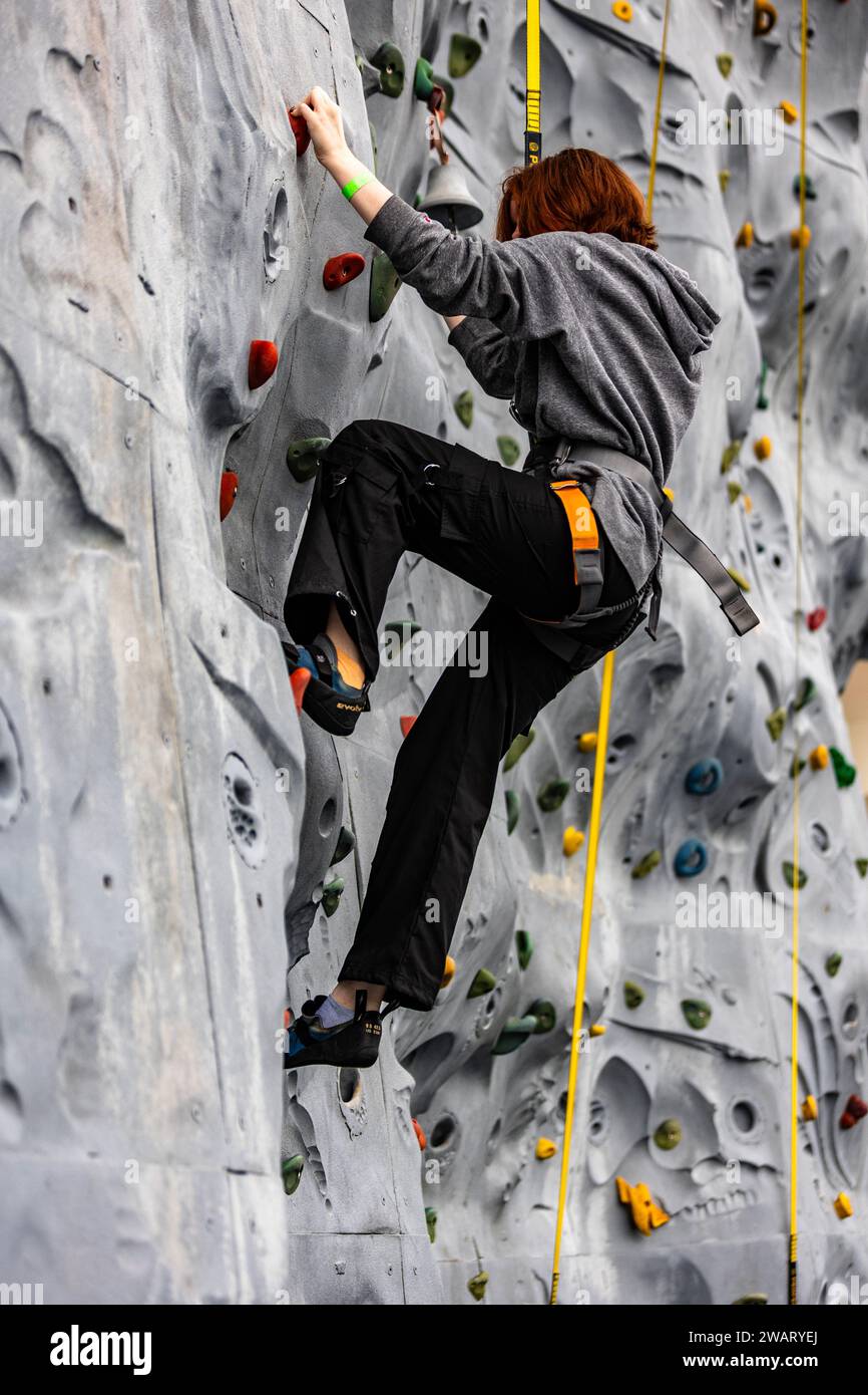 An active female scaling a challenging indoor rock wall Stock Photo - Alamy