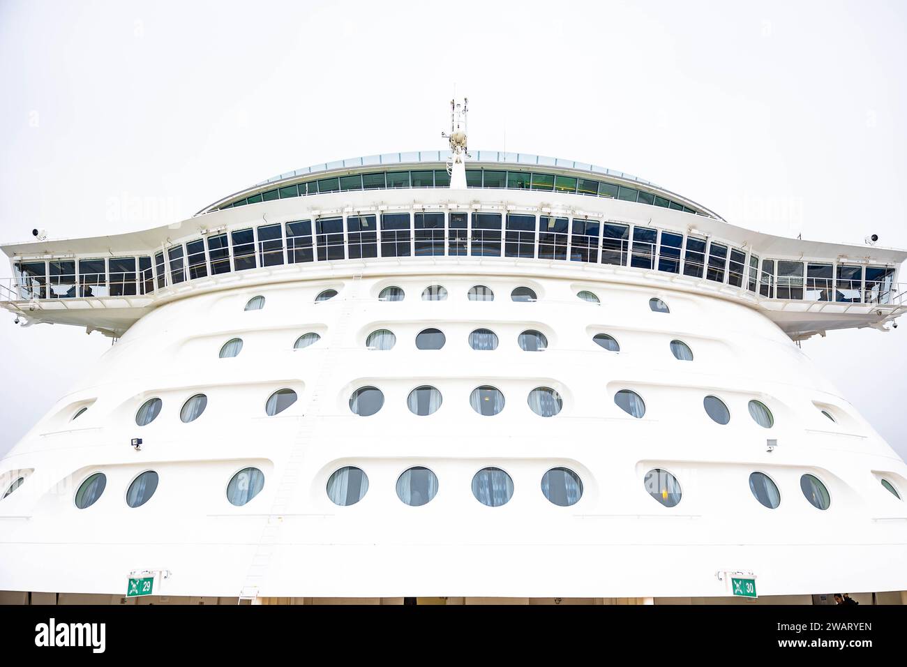 The exterior view of a tall luxury cruise ship tower illuminated by the ...