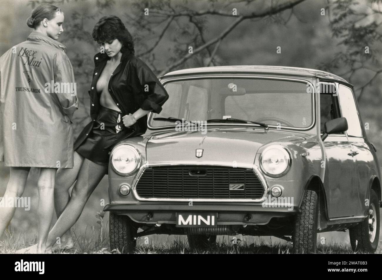 Two girls next to a Mini Morris car, UK 1970s Stock Photo - Alamy