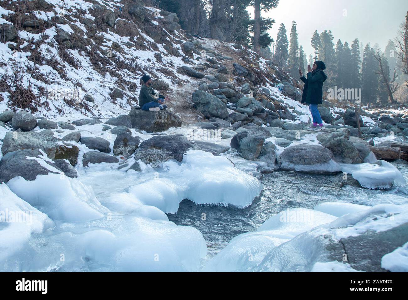 Pahalgam, India. 06th Jan, 2024. A woman captures a photo of a man ...