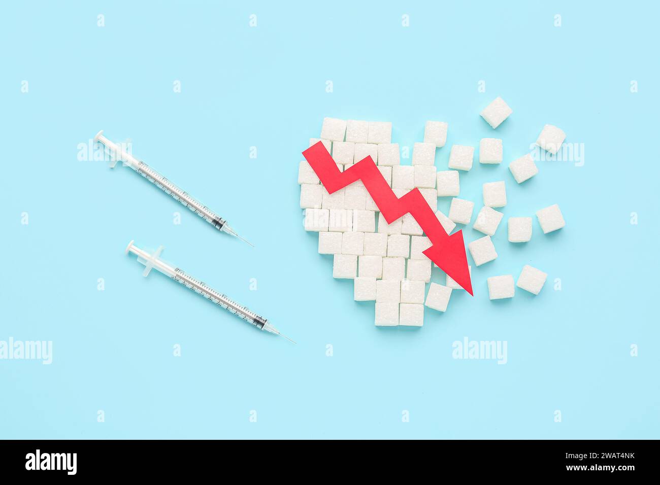 Heart made of sugar with arrow directed downwards and syringes for ...