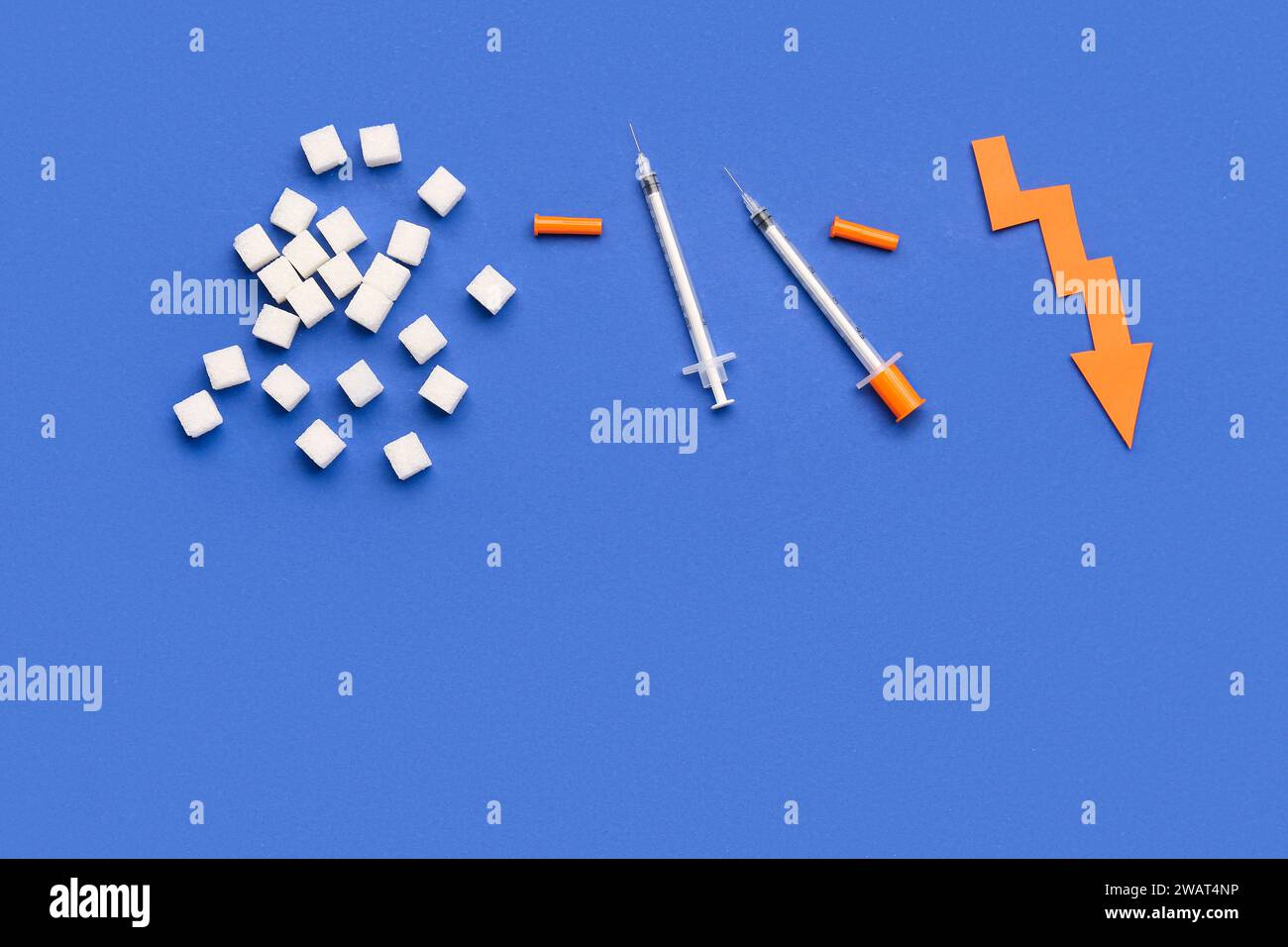 Sugar cubes with syringes for insulin injection and arrow directed ...