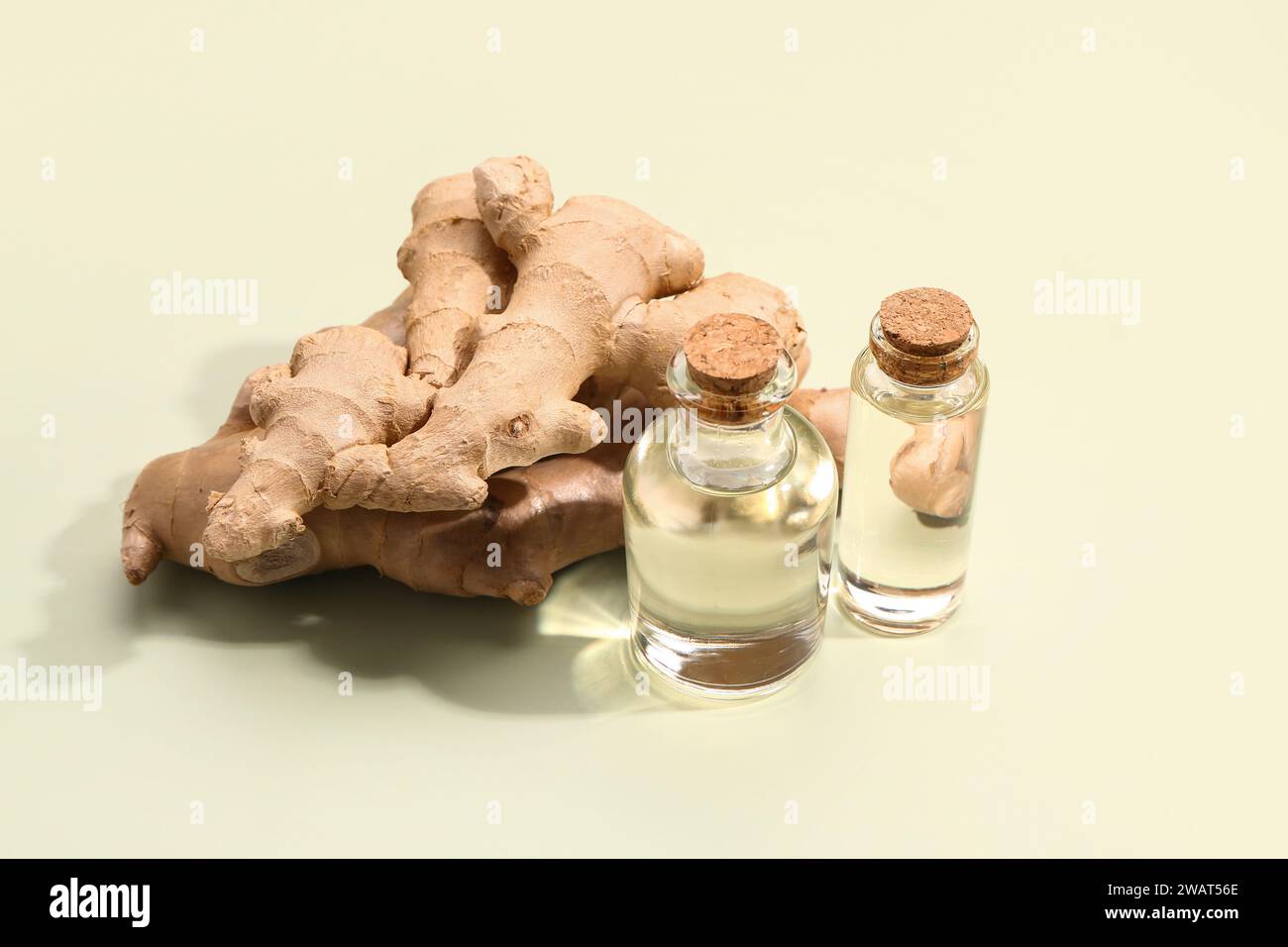 Bottles of ginger cosmetic oil on green background Stock Photo - Alamy