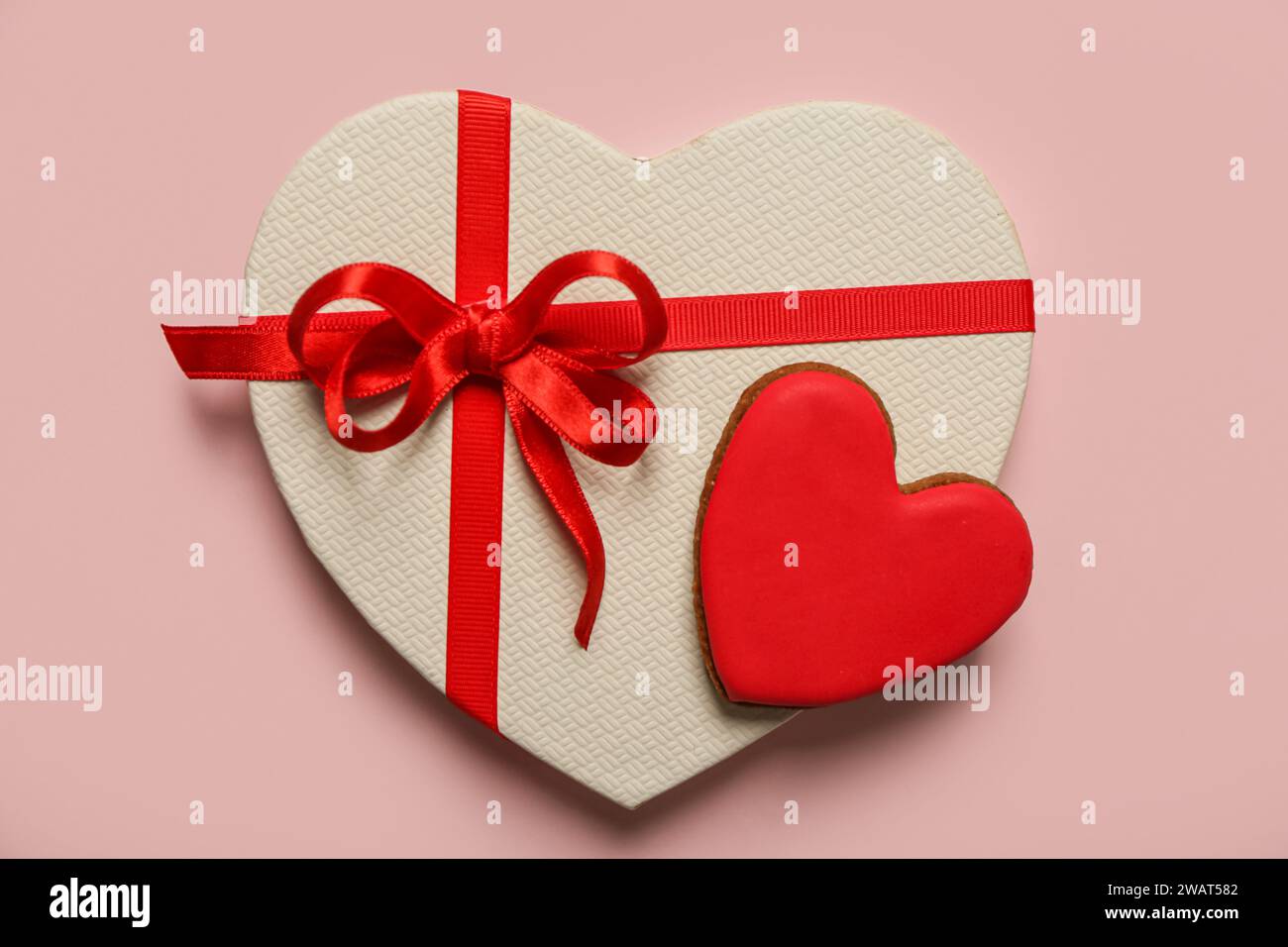 Heart shaped cookie and gift box on pink background. Valentine's day ...