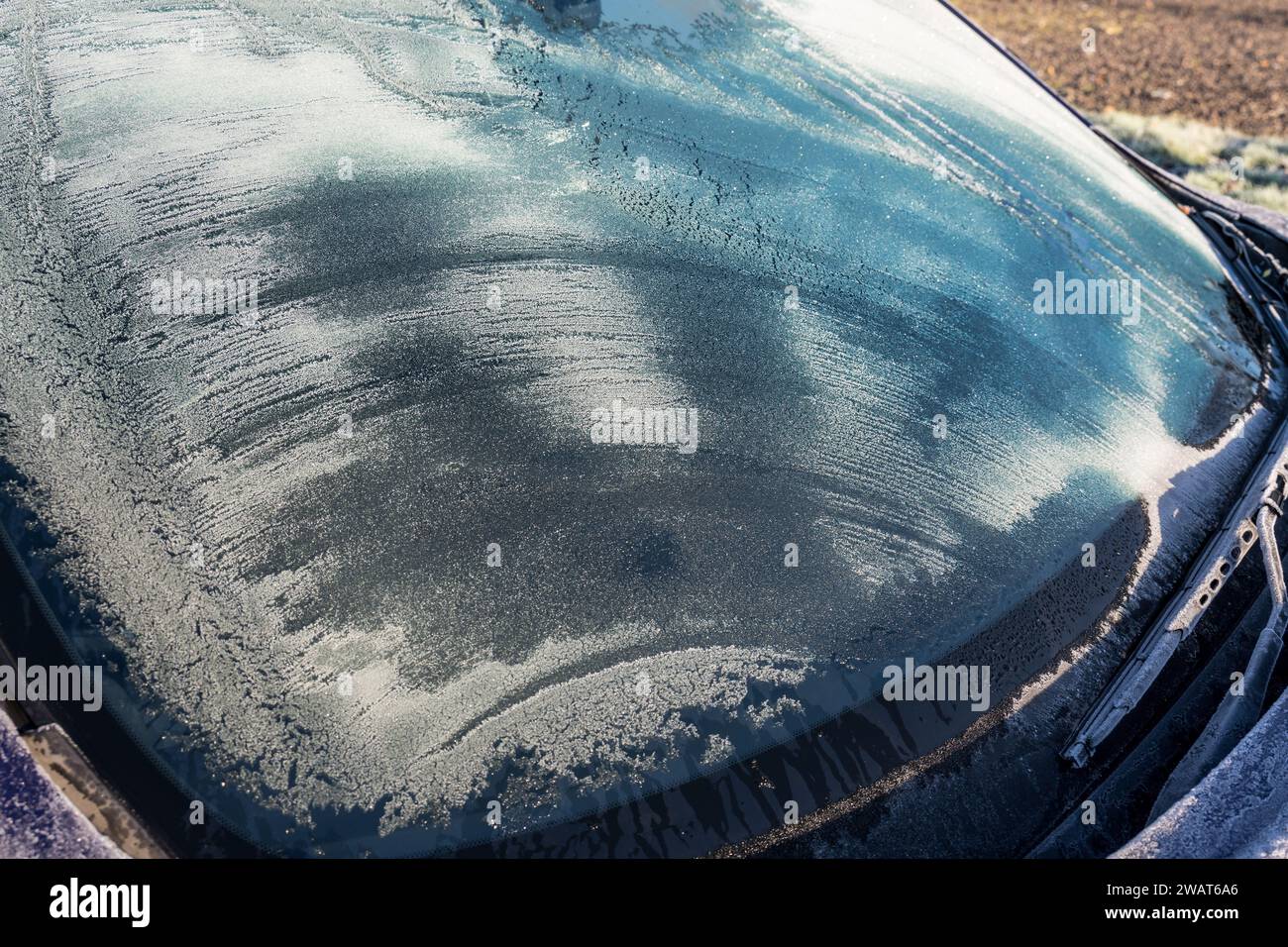 Ice on front screen of car during cold morning Stock Photo - Alamy