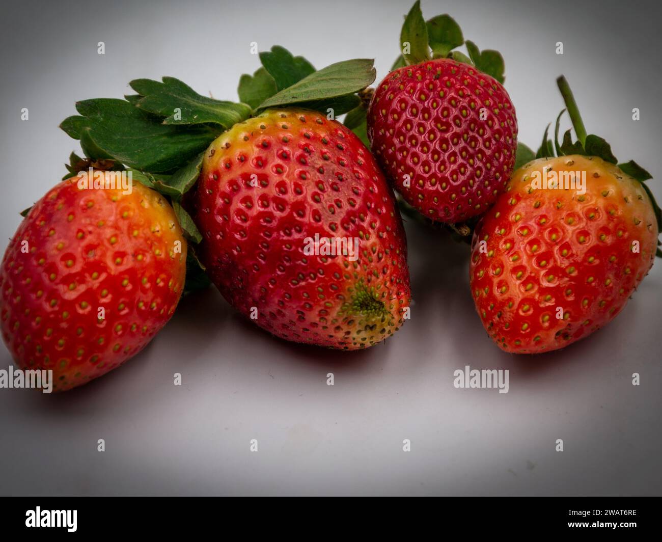 Fresh red strawberries scattered hi-res stock photography and images ...