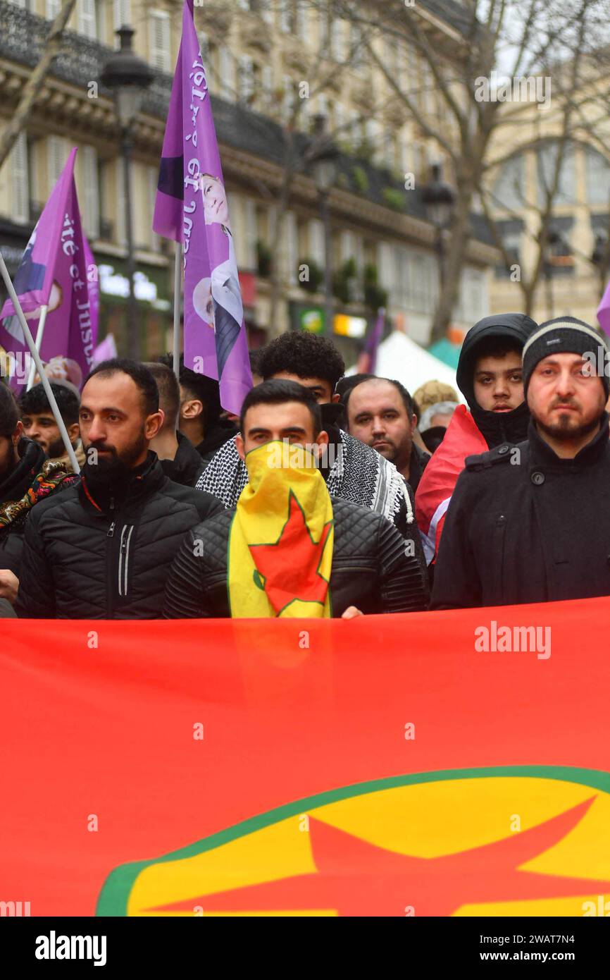 People hold a Kurdistan Workers' Party (PKK) flag and wave flags ...
