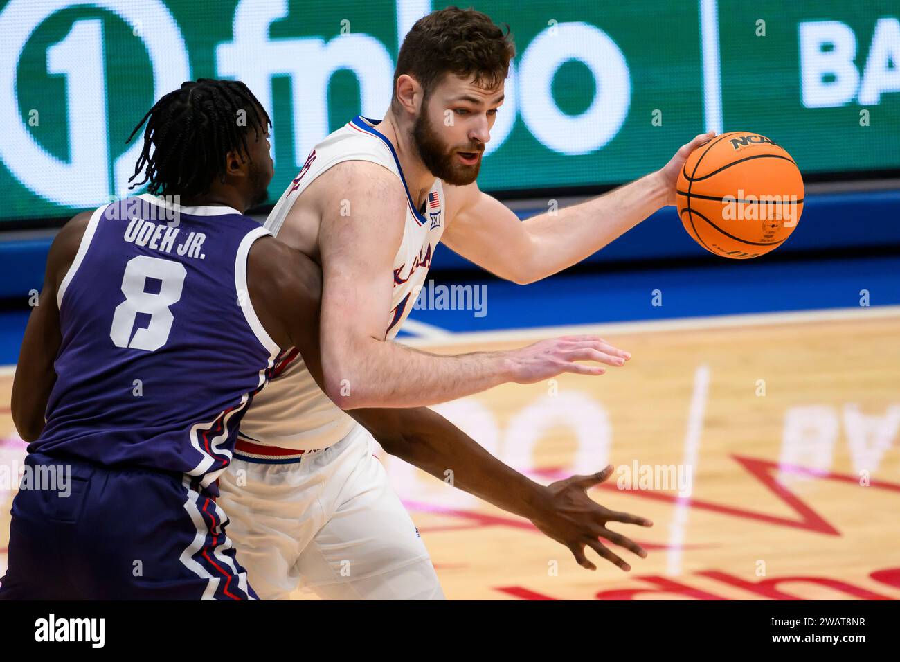 Kansas center Hunter Dickinson, right, is guarded by TCU center Ernest ...