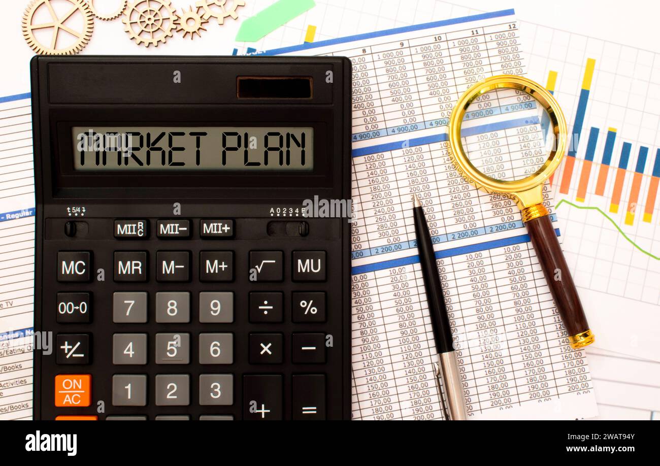 Marketing Plan written on note pad, office desk with electronic devices ...